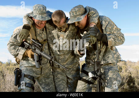US Army soldier carrying wounded friend Stock Photo - Alamy