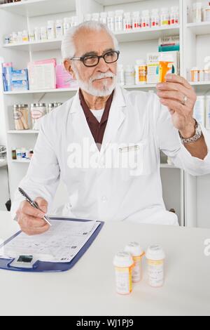 Hispanic man with beard working at pharmacy drugstore holding credit ...