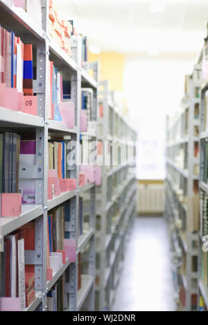 Color coded filing system on library shelves Stock Photo - Alamy