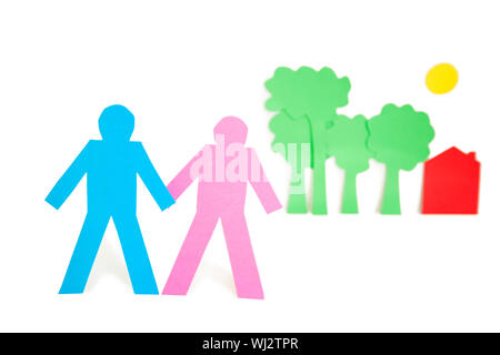 Paper cut outs representing a couple with trees and house over white ...