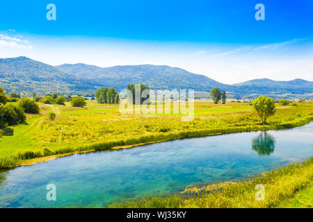 Beautiful nature landscape, Gacka river among grass banks, Lika region ...