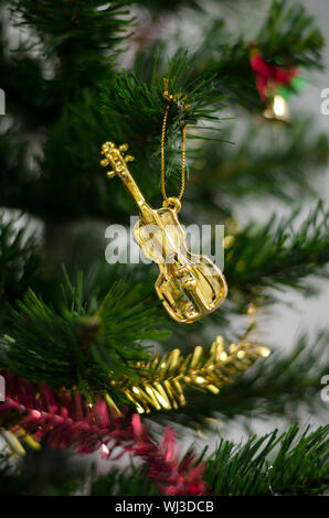 Violin with Christmas lights and decor on dark background Stock Photo ...