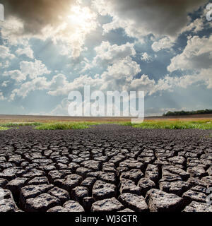 hot sun over drought earth with cracks Stock Photo - Alamy