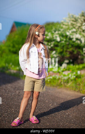 Little girl walking outdoor and having fun in the garden Stock Photo ...