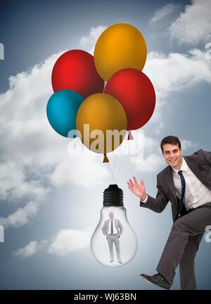 Businessman trapped in bulb Stock Photo - Alamy