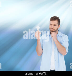 Composite image of sceptical model on white background holding a bulb ...