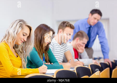 Students standing in line in classroom Stock Photo - Alamy