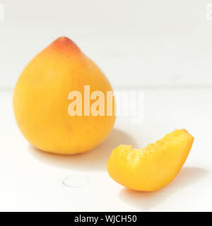 Yellow italian fresh peach percoche on the white wooden background with ...