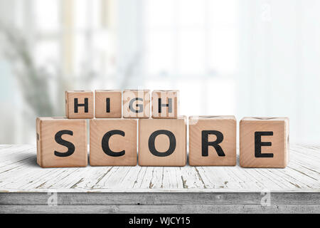 High score sign on a table in a bright home with green plants in the ...