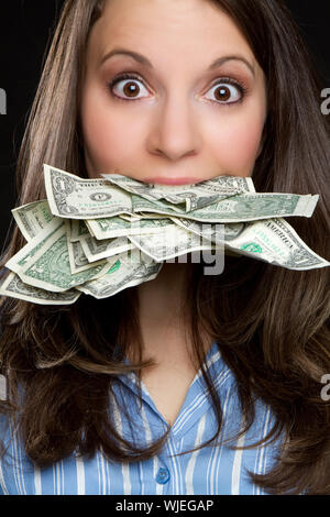 Woman eating money in mouth Stock Photo - Alamy