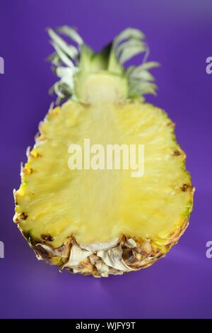 Pineapple with selective focus over purple background Stock Photo - Alamy