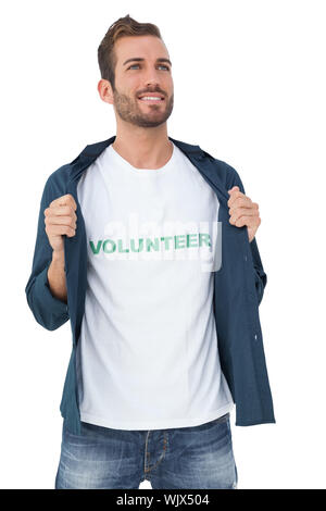 Young hispanic man wearing volunteer t shirt at donations stand making ...