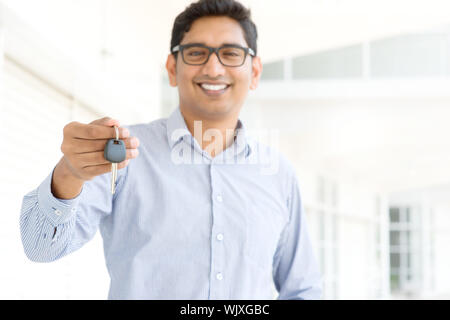 Young Asian Indian estate agent or salesman holding a key, India male ...