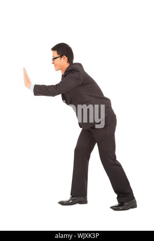 Asian business man push something isolated over white background Stock ...