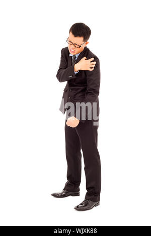 Young Businessman Having Shoulder Pain While Working At Computer Desk ...