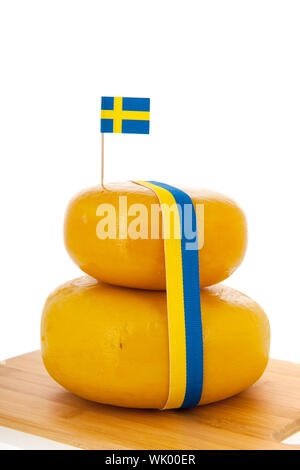 Two stacked whole Swedish cheeses isolated over white background Stock ...