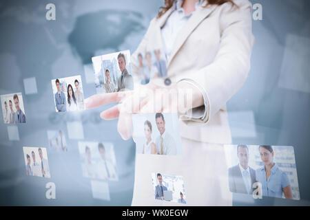 Stylish businesswoman presenting coworkers pictures Stock Photo - Alamy