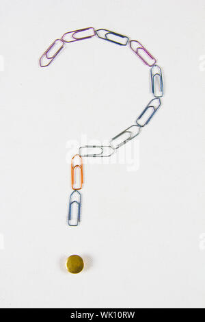 Paper clips with pins and question mark on pink background Stock Photo ...