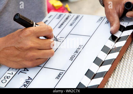 Labeling the Slate on set, film slate and film crew production set ...