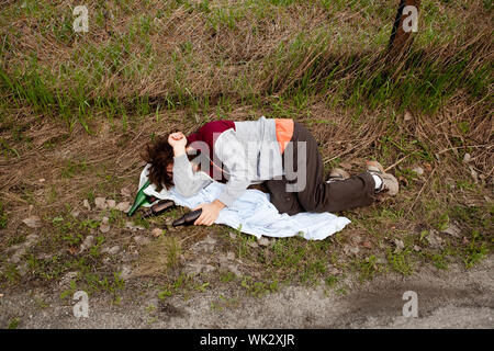 A drunk passed out in the ditch with a bunch of alcohol bottles Stock ...