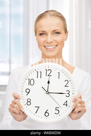 picture of woman holding big clock over white Stock Photo - Alamy