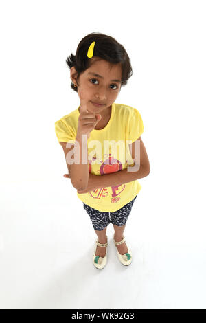 High angle shot of child hand draws a orange pencil with white ...