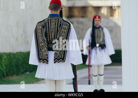 Evzones, members of the Greek Presidential Guard, backdropped by the ...