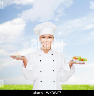 Smiling young chef deciding on best fruits in grocery shop Stock Photo ...