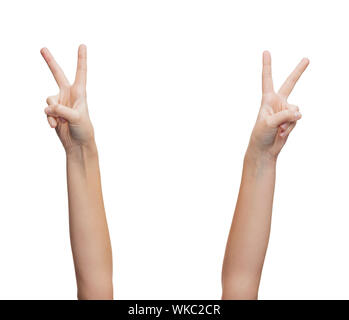 Woman showing victory gesture by her hands isolated on gray background ...