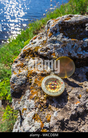 Orientation Concept - Compass Abandoned on the Rocks Stock Photo - Alamy