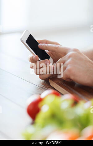 hand holding a smartphone with many people pictures on the screen ...