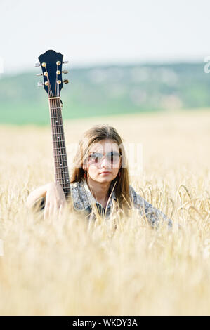 Rocking girl on a nature with guitar Stock Photo - Alamy