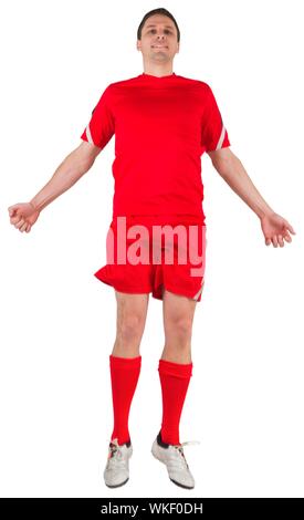 Fit football player jumping up on white background Stock Photo - Alamy