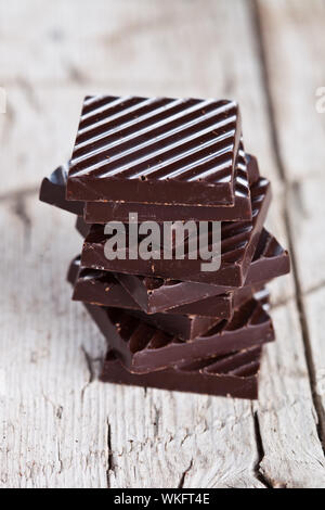 chocolate sweets stack on rustic wooden background Stock Photo - Alamy