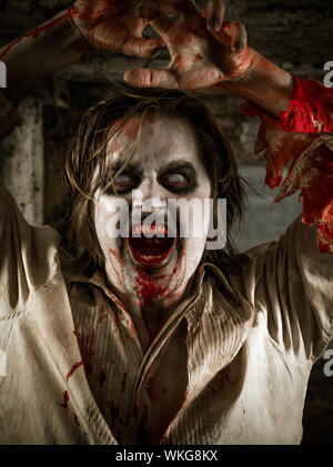Photo of a hungry zombie covered with blood at the window Stock Photo ...
