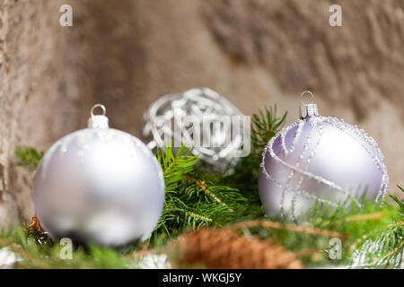 Silver Christmas ornaments in leaves Stock Photo - Alamy