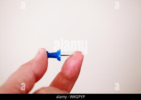 hand holding push pin Stock Photo - Alamy