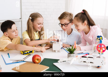 Stem education. Children creating robots at classroom Stock Photo - Alamy