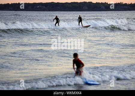 Surfers riding wave on Higgins Beach.Scarborough.Maine.USA Stock Photo ...