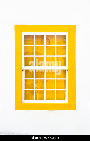 Decorative, colonial, yellow, vintage, window on a white wall in Paraty ...