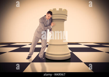 Businessman pushing chess piece against white background with vignette ...