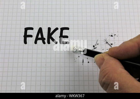 Hand erasing with pencil eraser on white background Stock Photo - Alamy