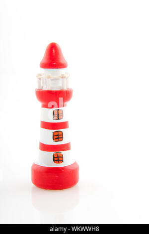 Red wooden miniature lighthouse isolated over white background Stock ...