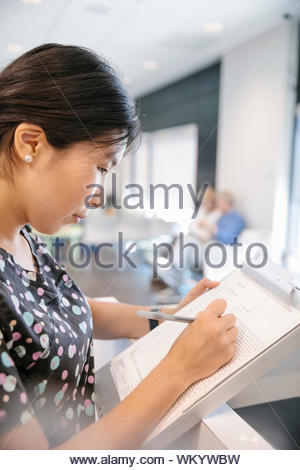 Nurse filling out form Stock Photo - Alamy