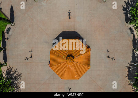 Aerial view of orange octagonal kiosk in the center of the public ...