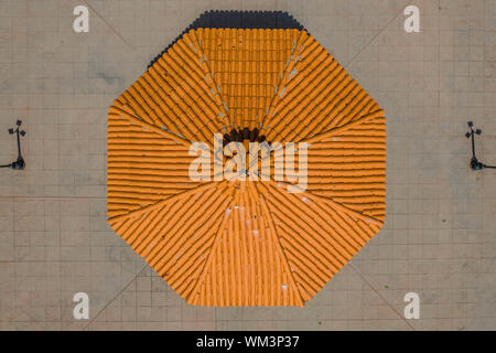 Aerial view of orange octagonal kiosk in the center of the public ...