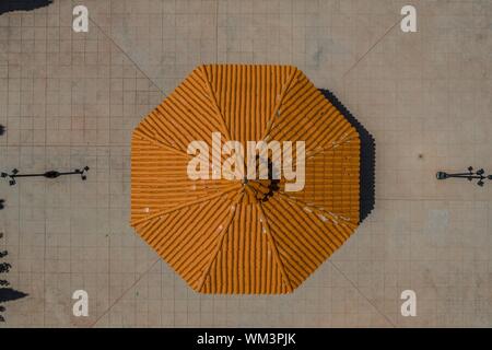 Aerial view of orange octagonal kiosk in the center of the public ...