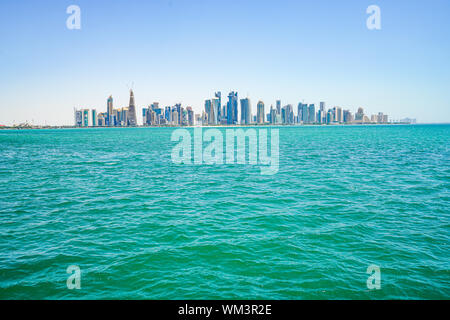 Al Dafna architecturally modern sykline across Dhow Harbour with bow ...