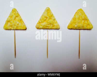 triangle chips on white background Stock Photo - Alamy