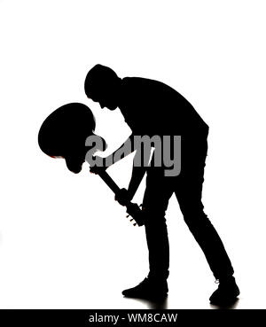 silhouette of a man smashing his guitar Stock Photo - Alamy